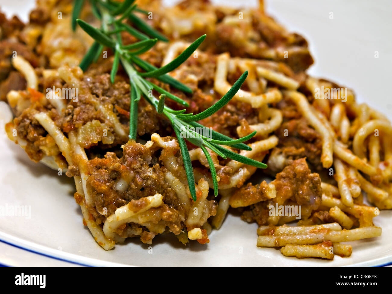 A serving of spaghetti with a sprig of Rosemary on top Stock Photo - Alamy