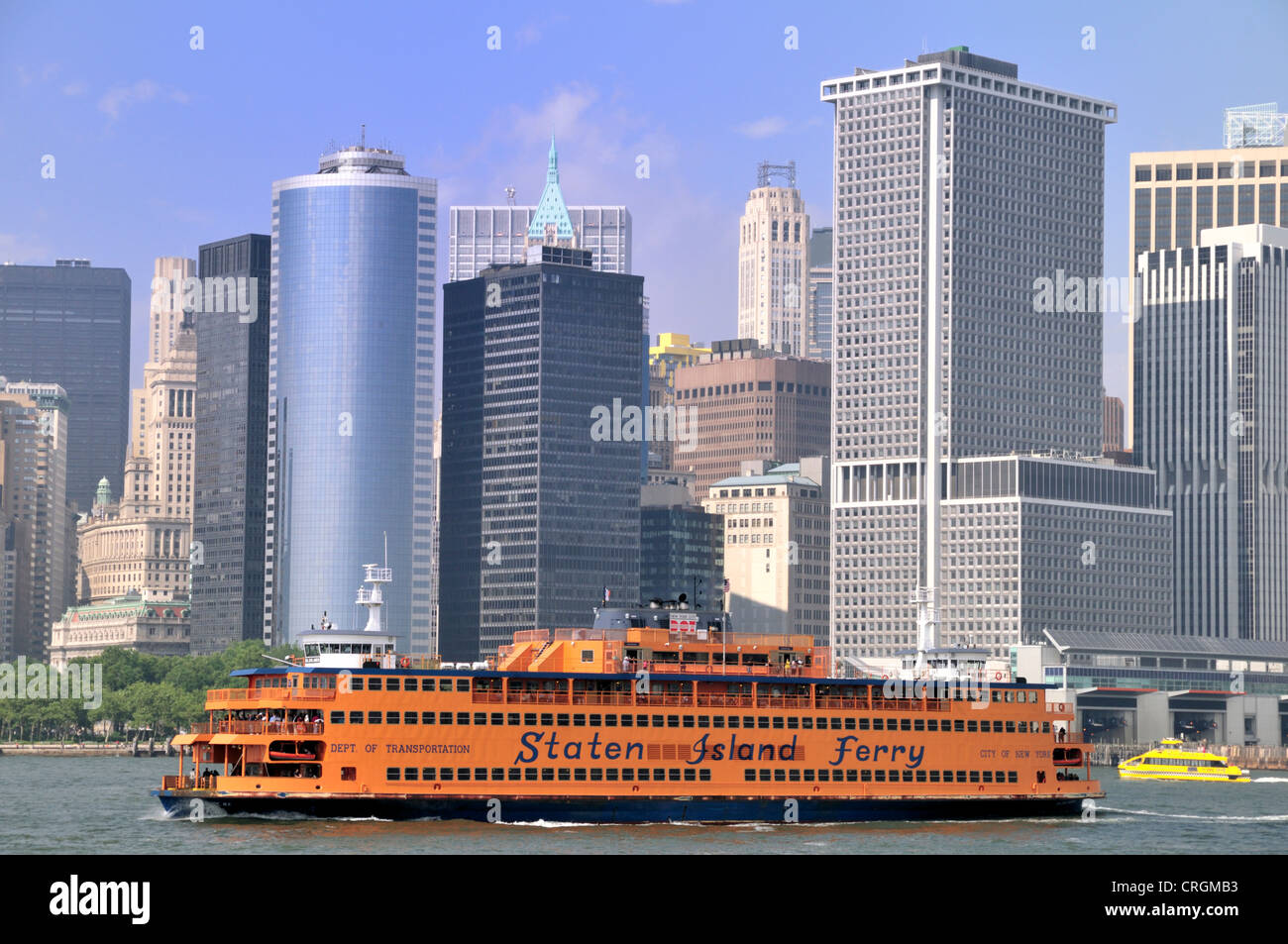 The Staten Island Ferry passes Battery Park as New York skyscrapers ...