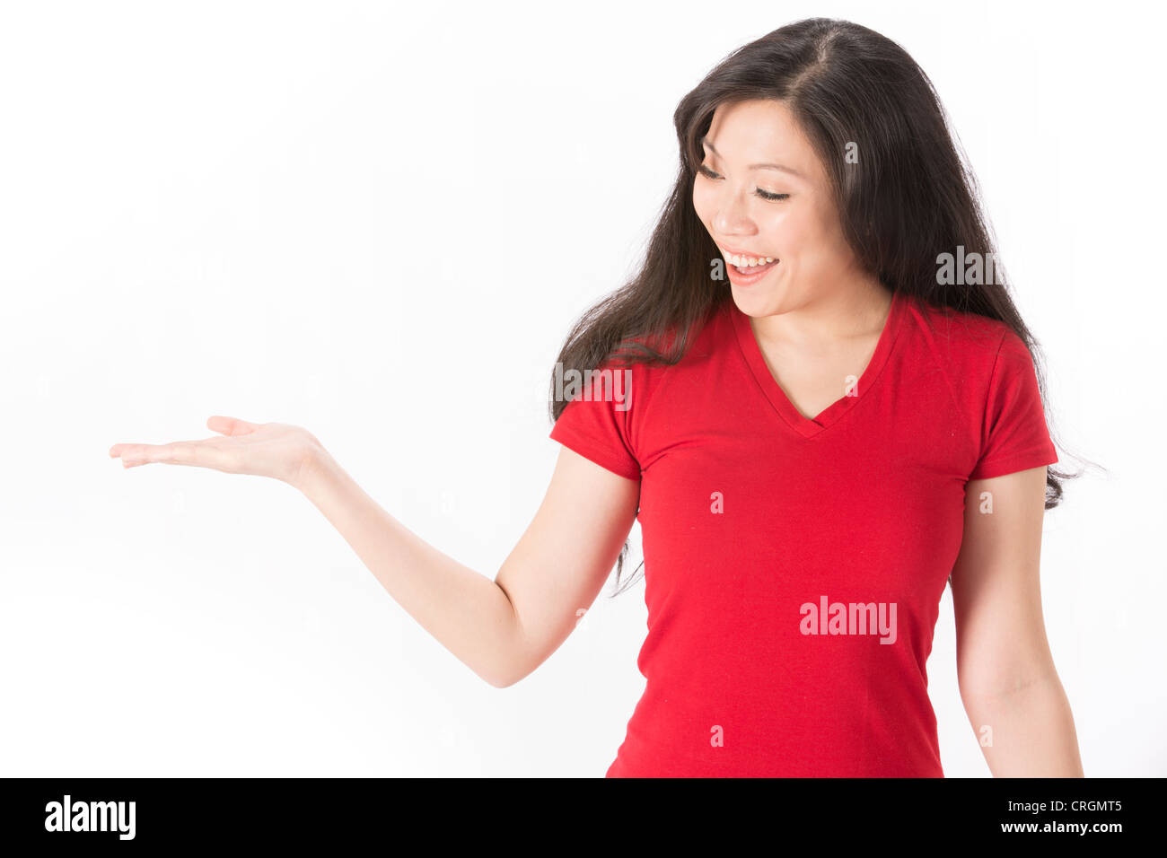 Happy Asian woman holding out her hand to show your message. Isolated ...