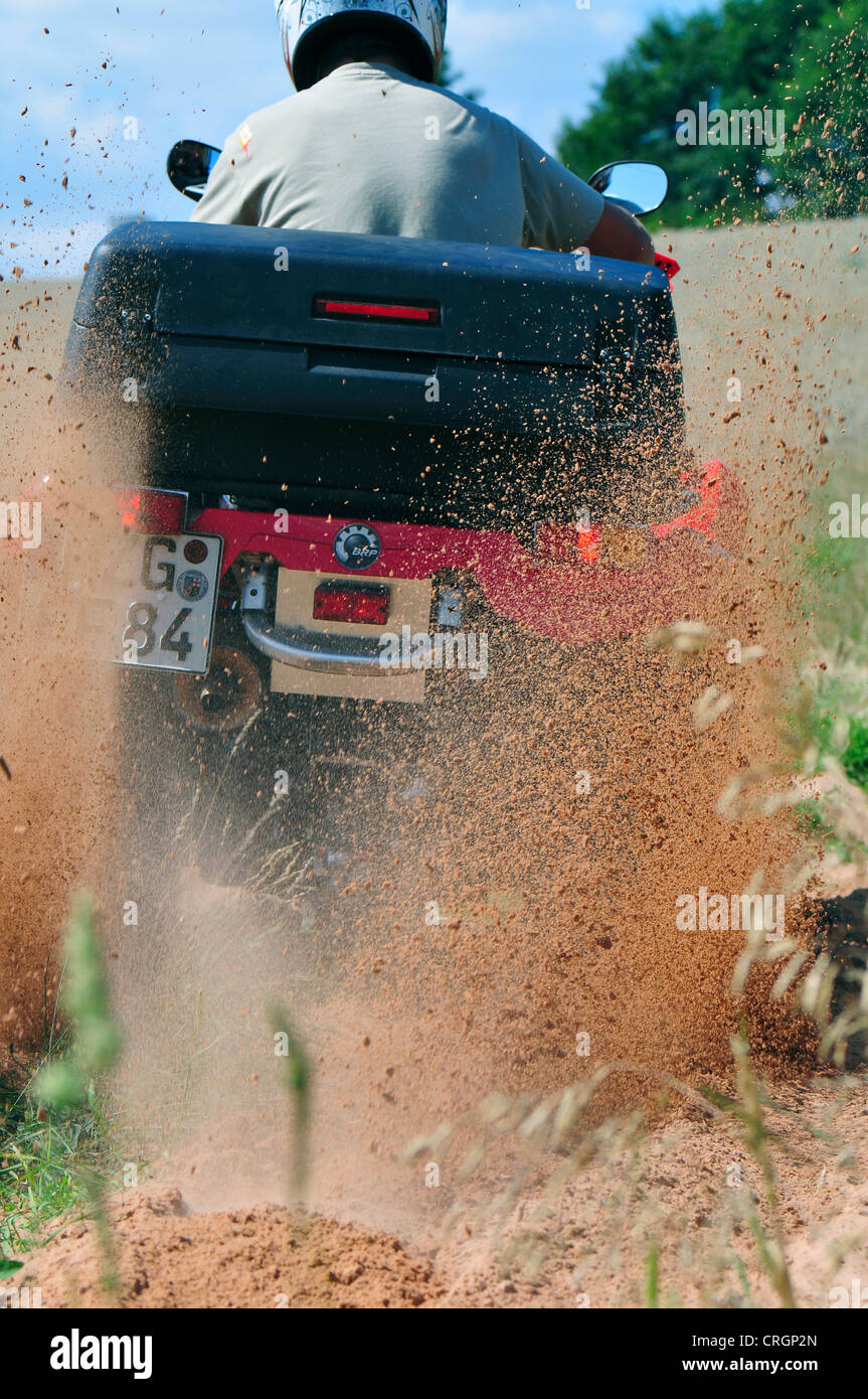 throwing tyres of a quad, Germany, Saarland Stock Photo - Alamy