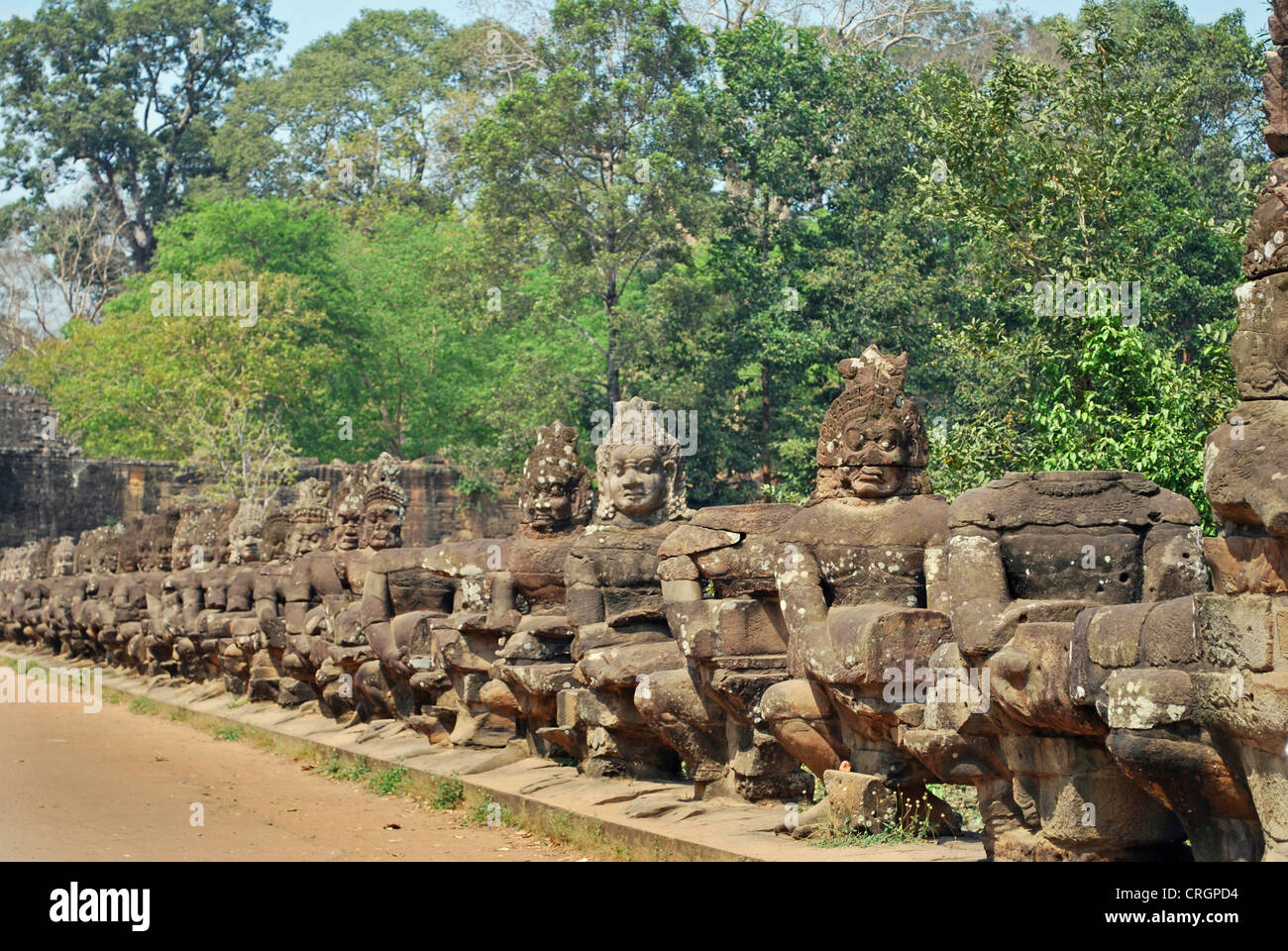 statues on the bridge leading to Victory Gate of Angkor Thom in temple ...