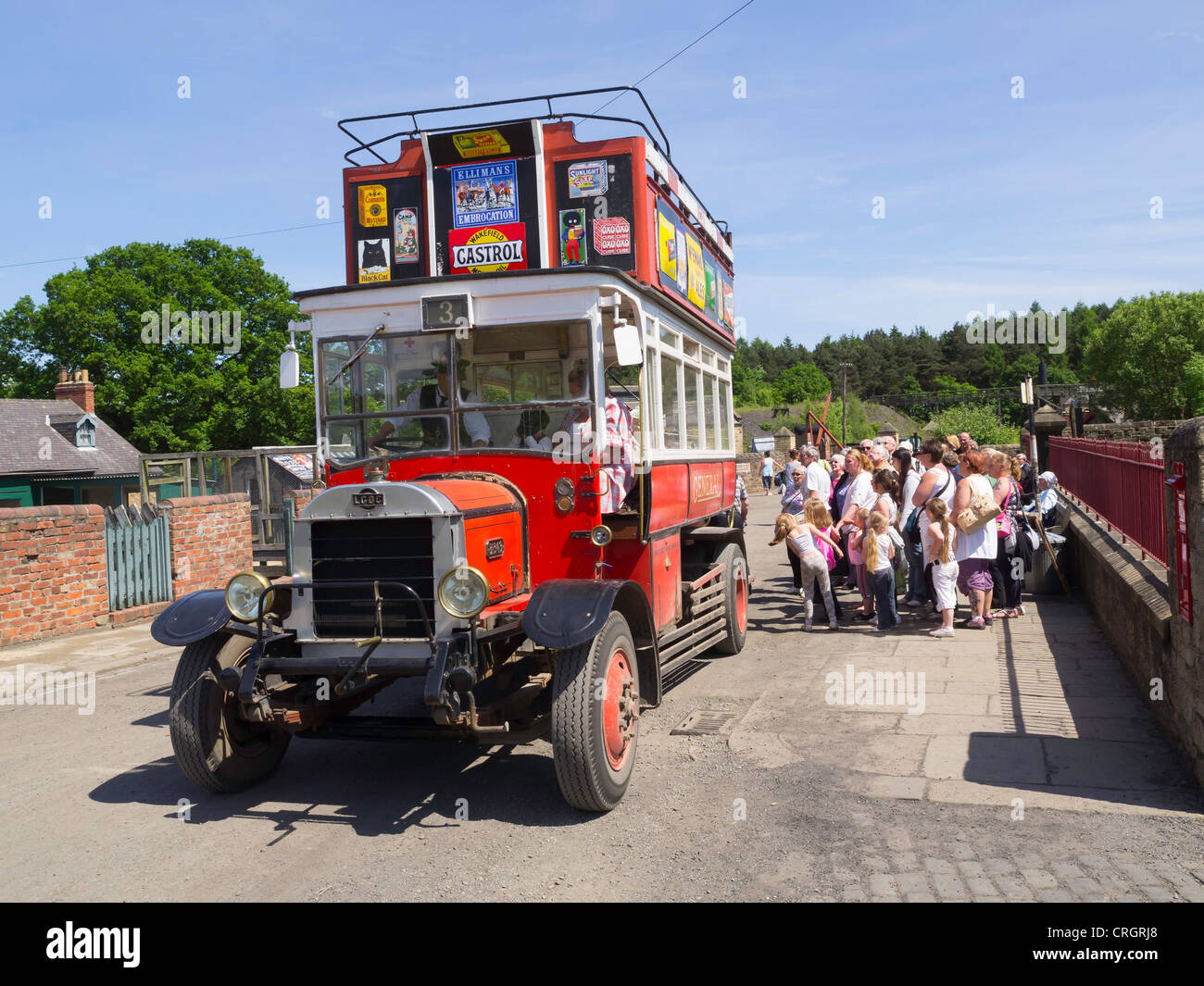 Passengers queue to board replica London General Omnibus Co bus in the ...