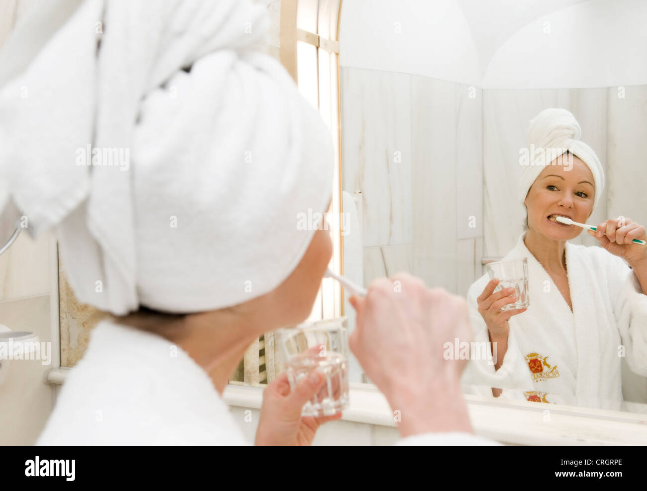 young woman in bath brushing teeth Stock Photo - Alamy