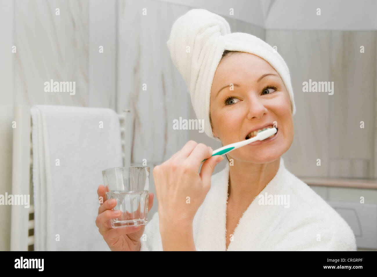 young woman in bath brushing teeth Stock Photo - Alamy