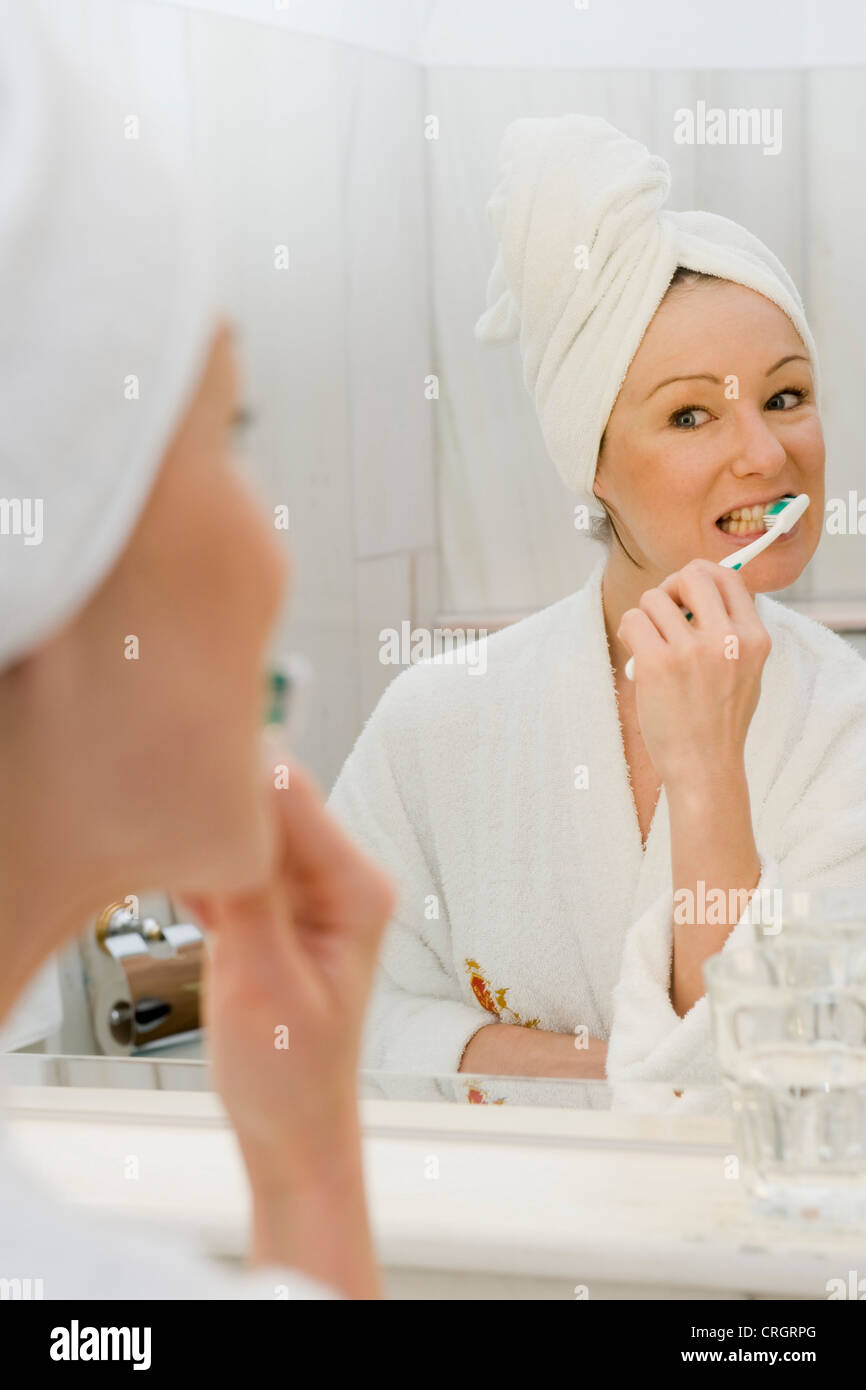 young woman in bath brushing teeth Stock Photo - Alamy