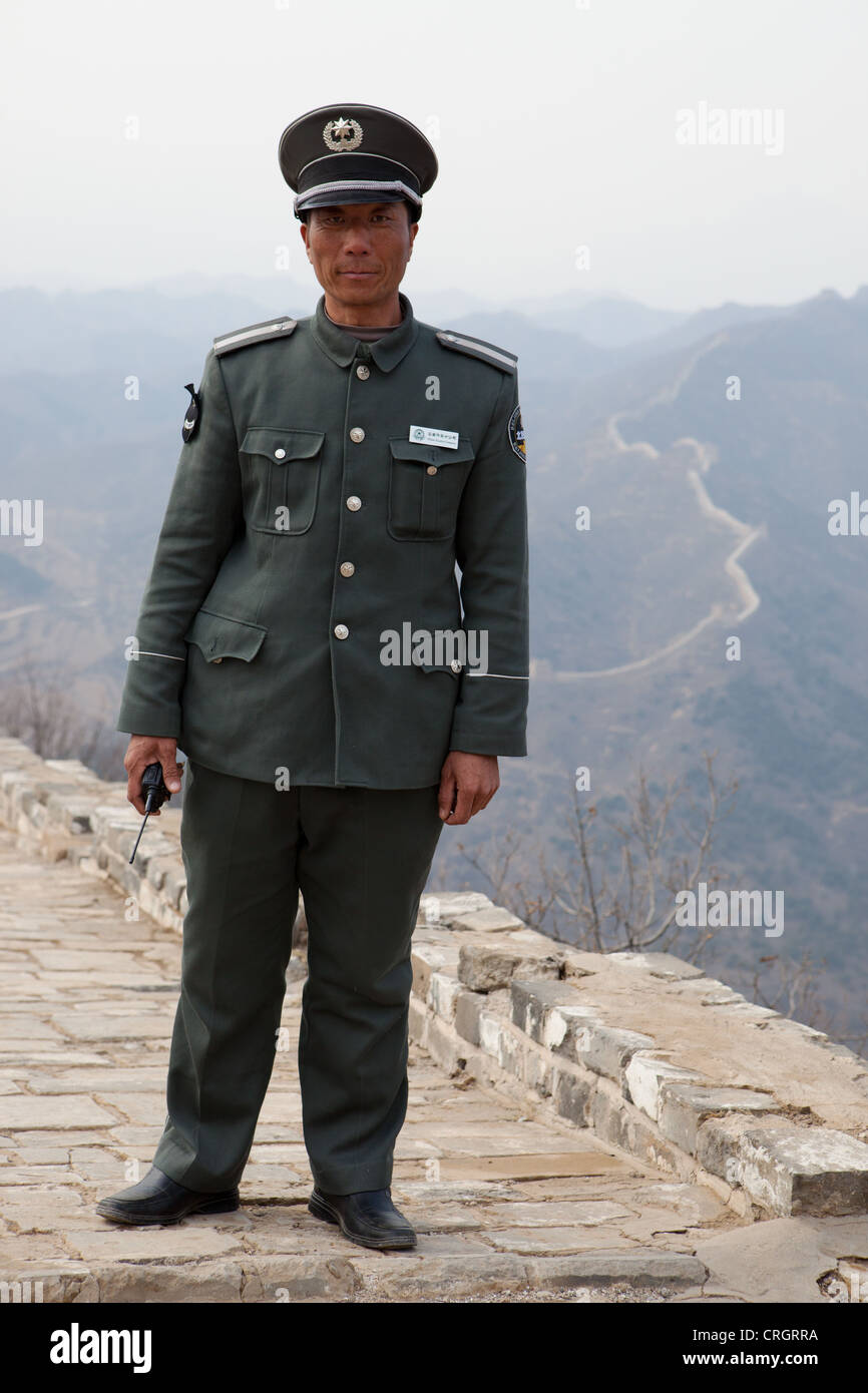 Portrait of a security guard holding walkie-talkie at Simatai Great ...