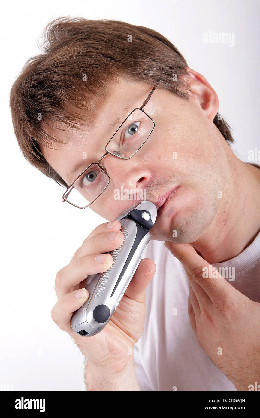 Man shaving with electric razor Stock Photo - Alamy