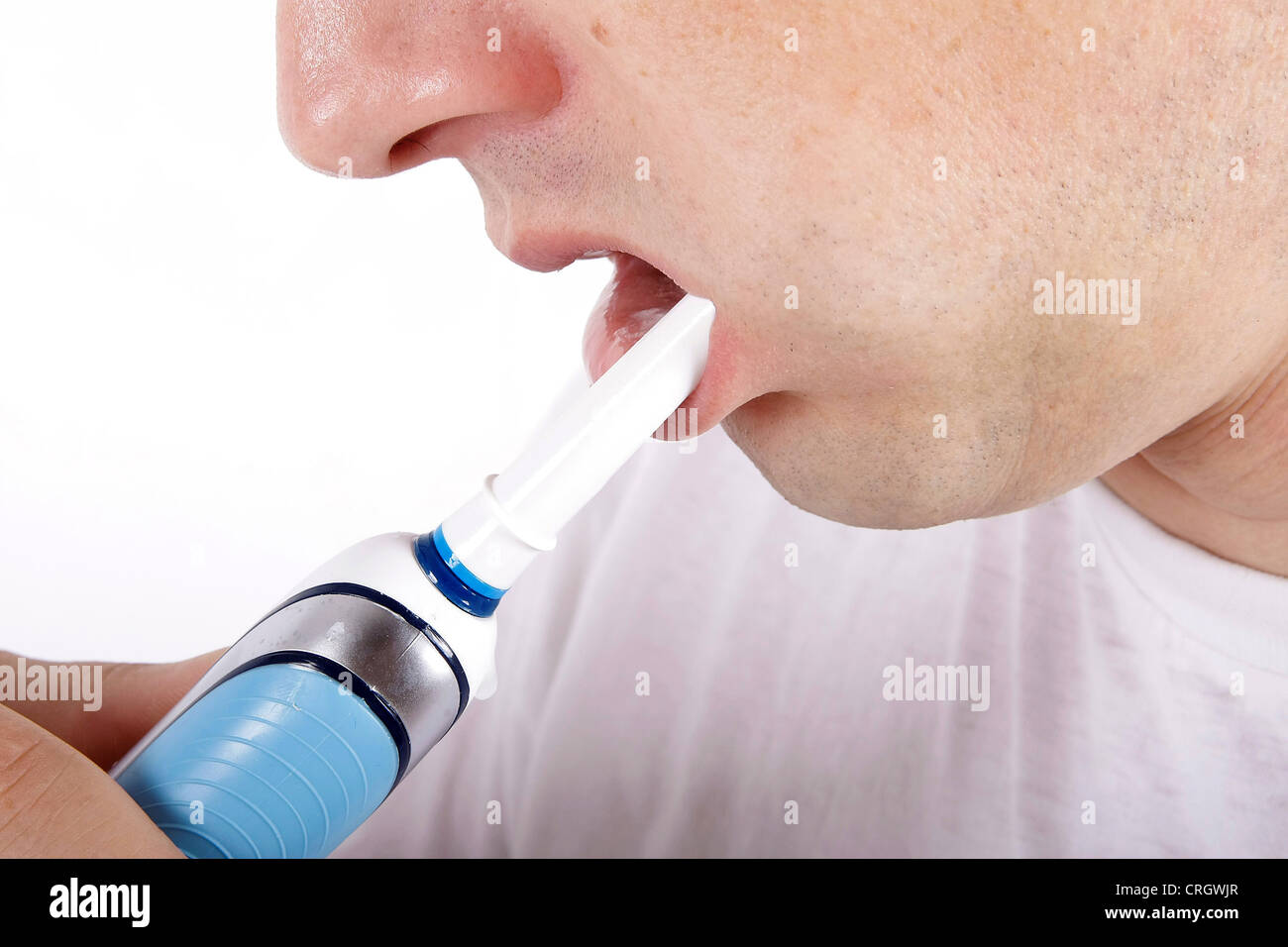 Man brushes teeth electric brush hi-res stock photography and images ...