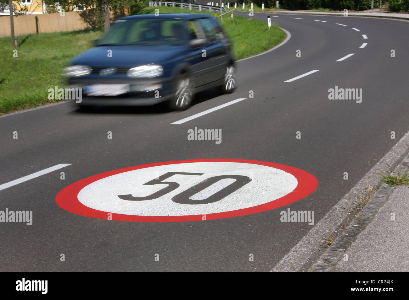 Tempo 50 traffic sign painted on street Stock Photo - Alamy