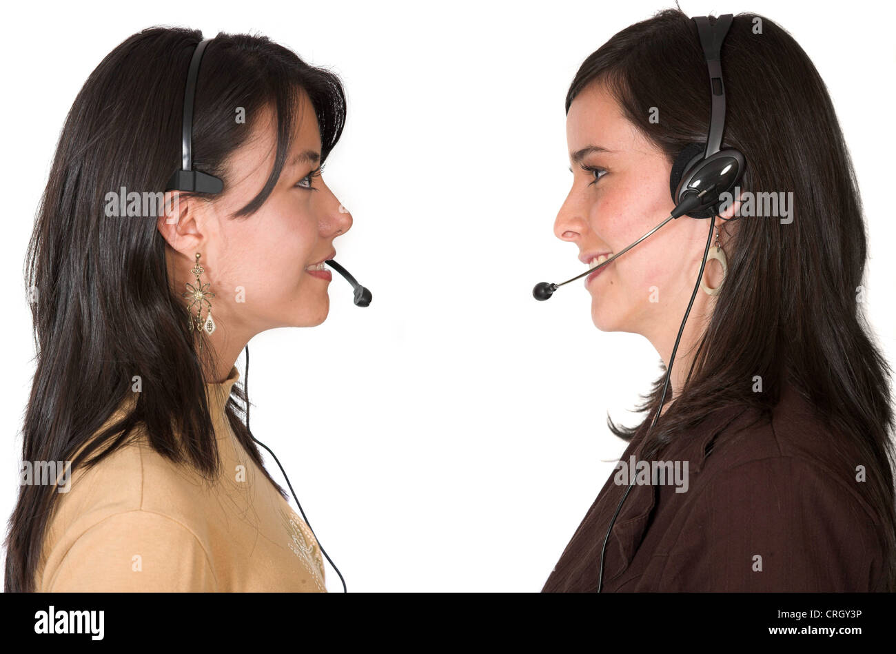 two women with headsets face to face Stock Photo - Alamy