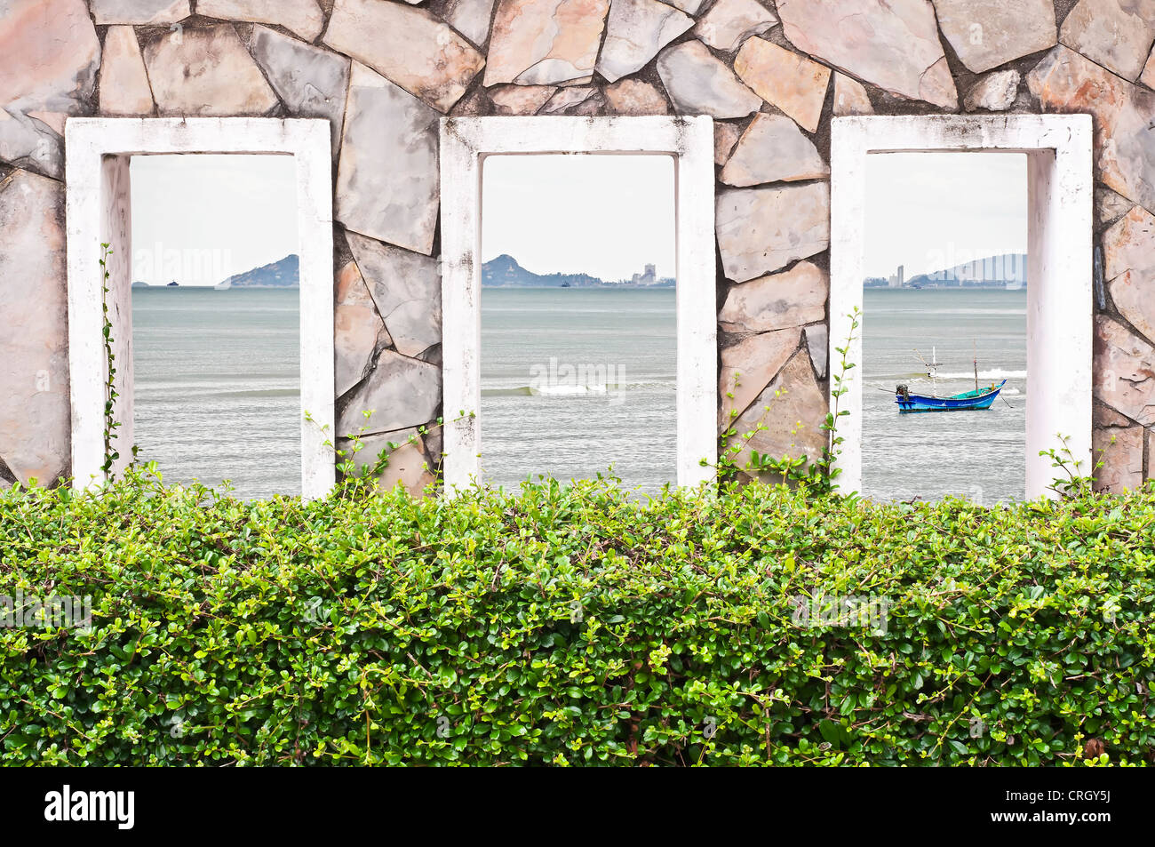 Seascape behind stone wall window Stock Photo - Alamy