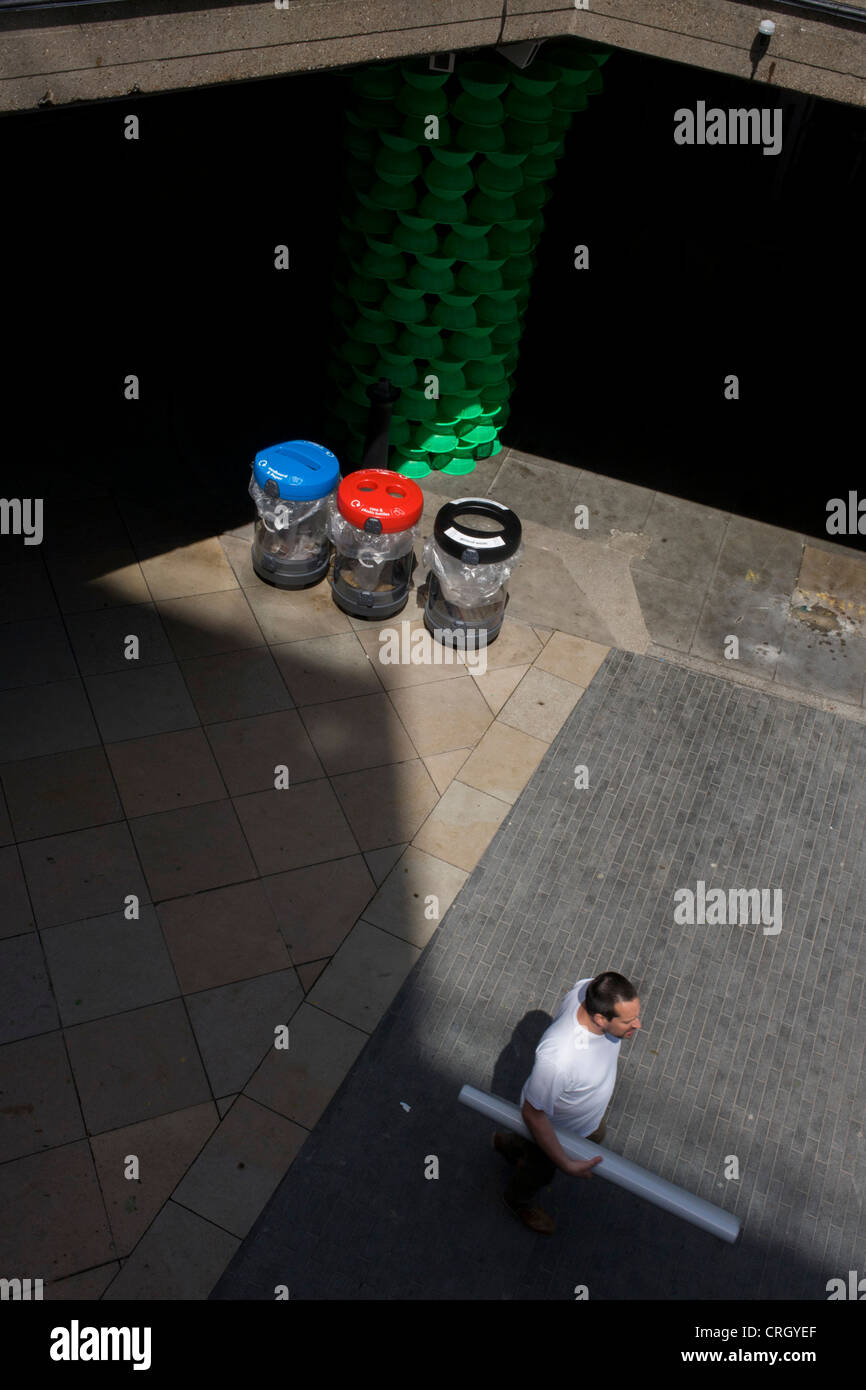 Three recycling bins seen from above in Southbank's pedestrian pavement ...