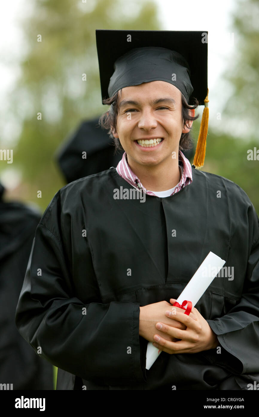 smiling graduate standing outdoors with his diploma Stock Photo - Alamy