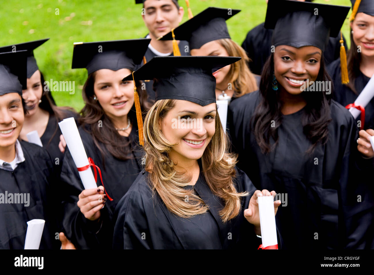 Smiling group of female graduates with gown hi-res stock photography ...