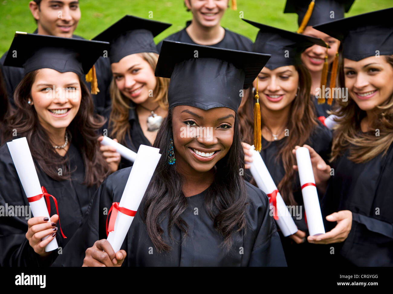 group of female graduates with gown, mortarboard and diploma Stock ...