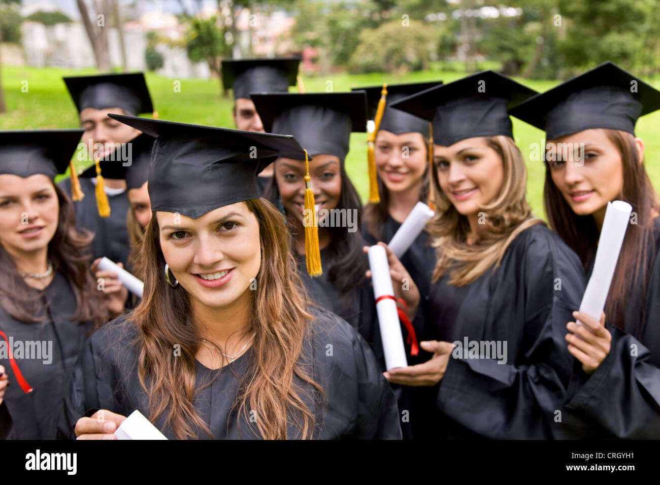 Smiling group of female graduates with gown hi-res stock photography ...