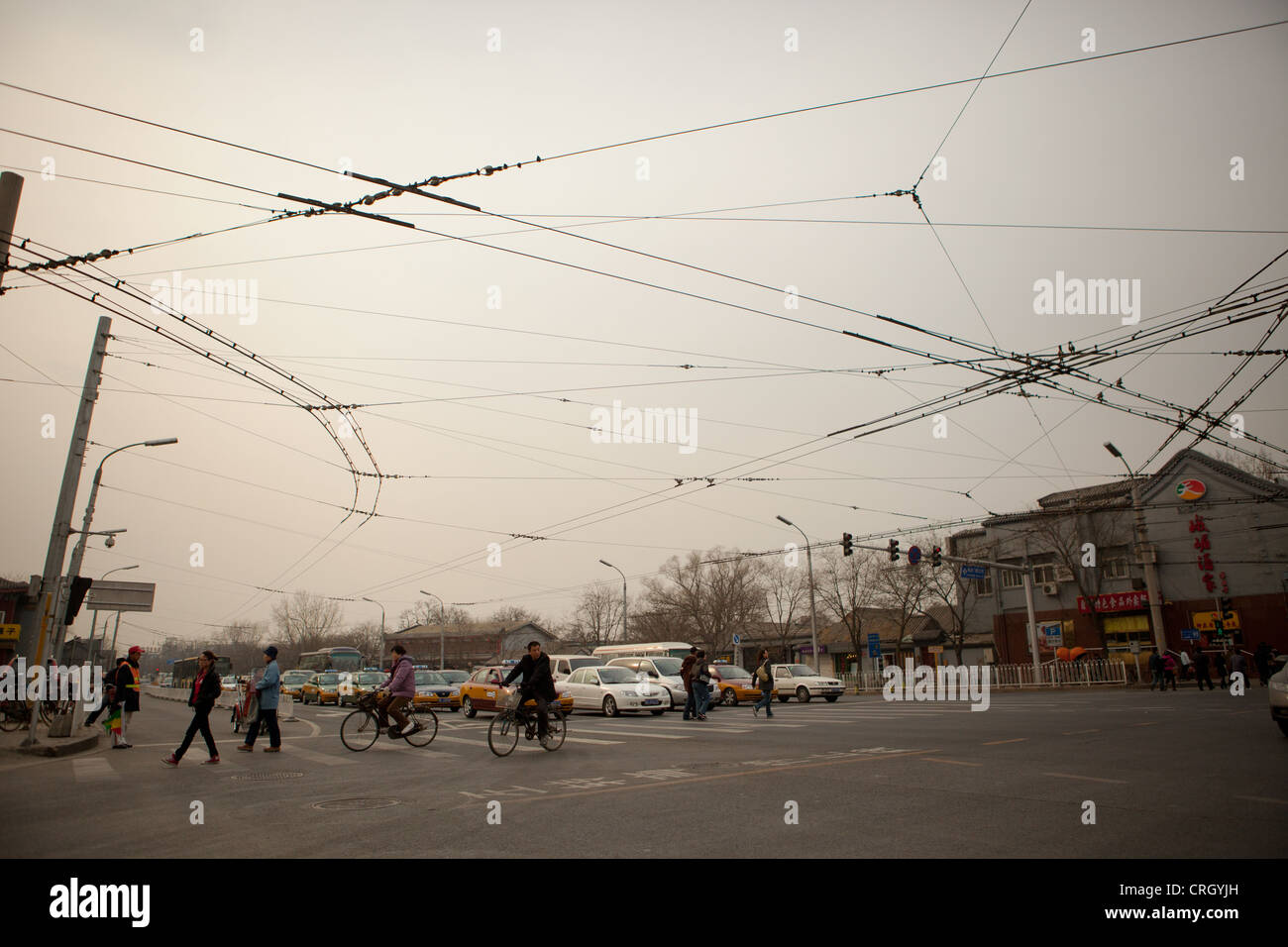 Traffic on road with electric tram power cables in sky, Beijing, China ...