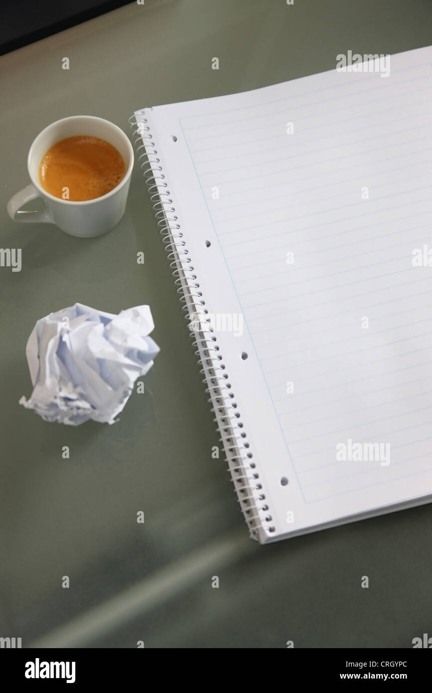 college block, crumpled paper ball and coffee cup Stock Photo - Alamy