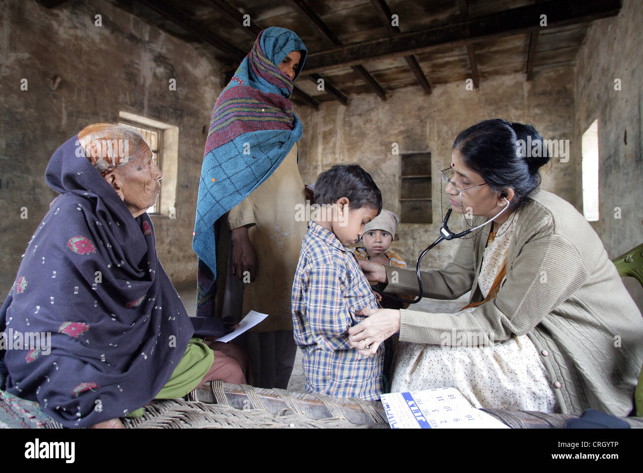 Volunteer Doctor (right) examines sick inhabitants of a village in ...