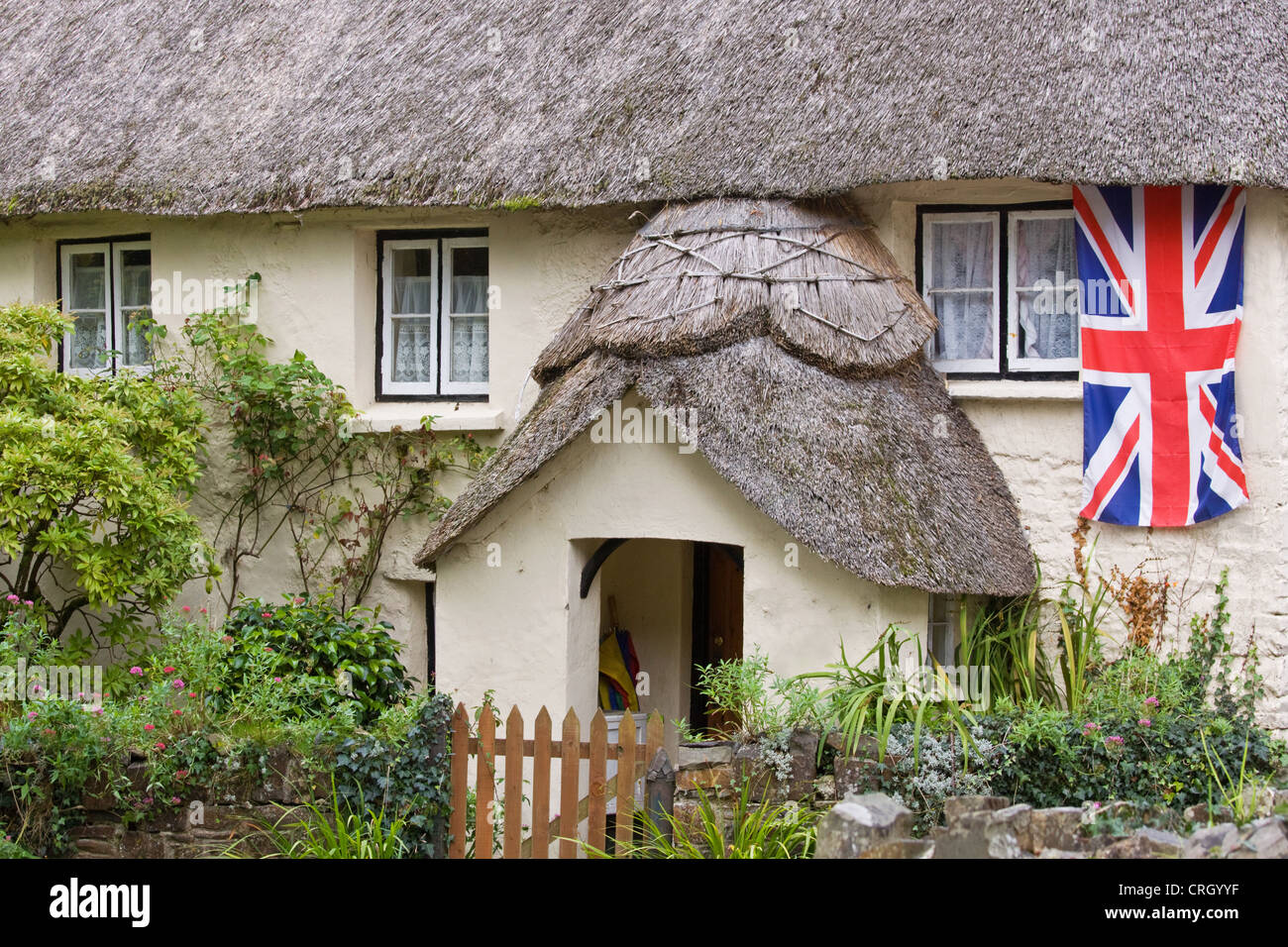 Old Devon cottage with traditional thatched roofing decorated with the ...