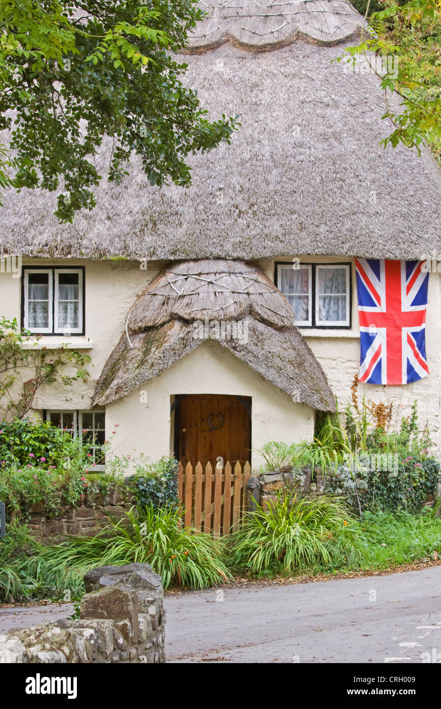 Old Devon cottage with traditional thatched roofing decorated with the ...