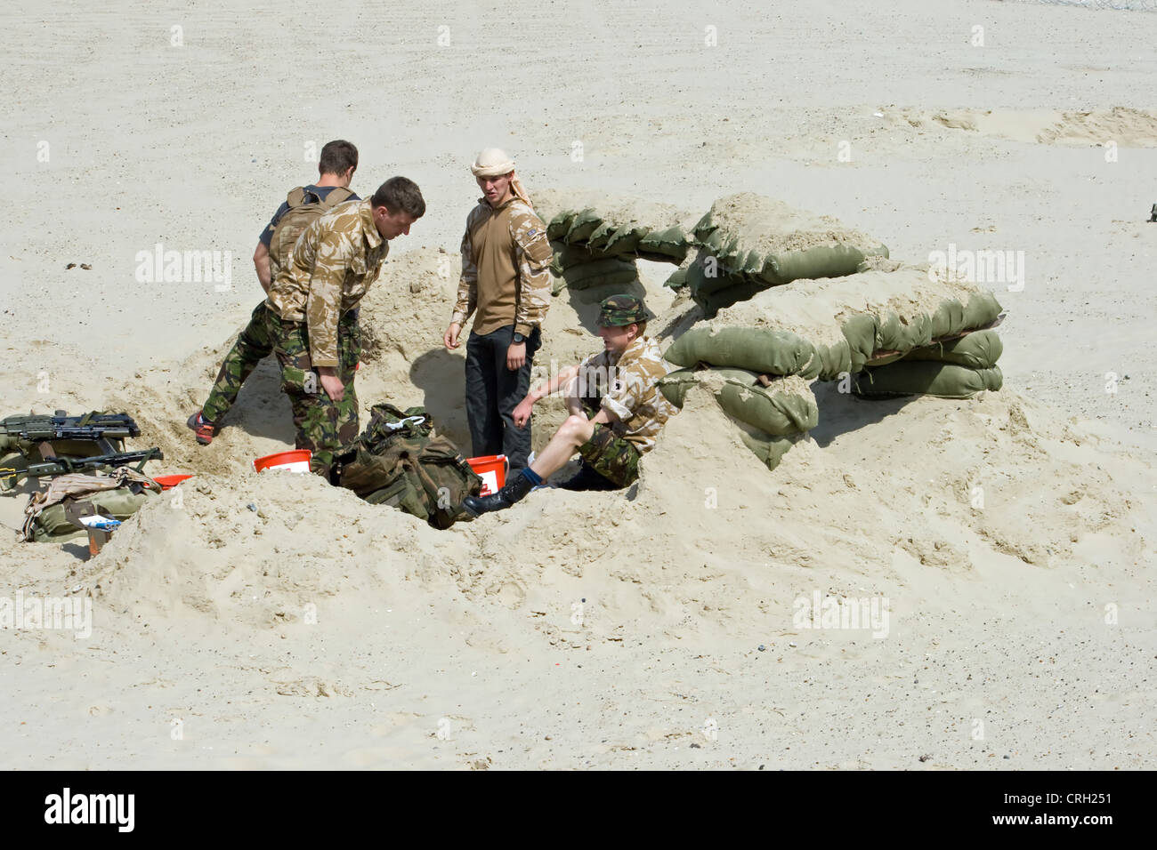 Soldiers in a fox hole for a display on Weymouth beach as part of the ...
