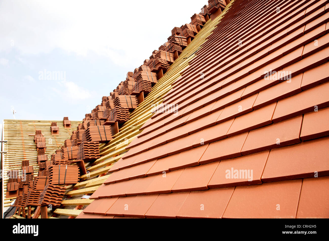 stacks of roof tiles ready to be fitted on roof Stock Photo - Alamy
