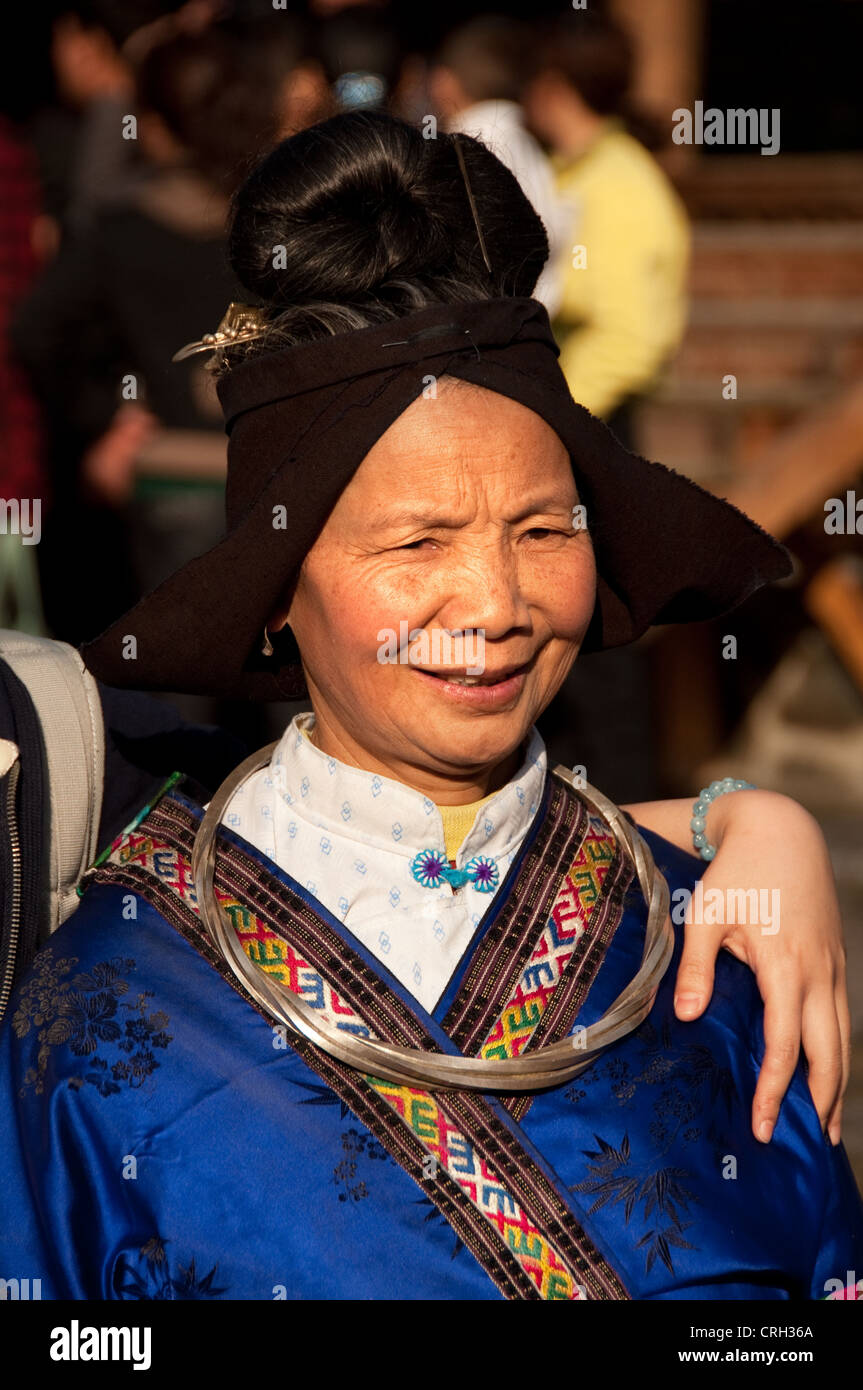 An elderly Miao woman with traditional clothes, hairstyle and silver ...