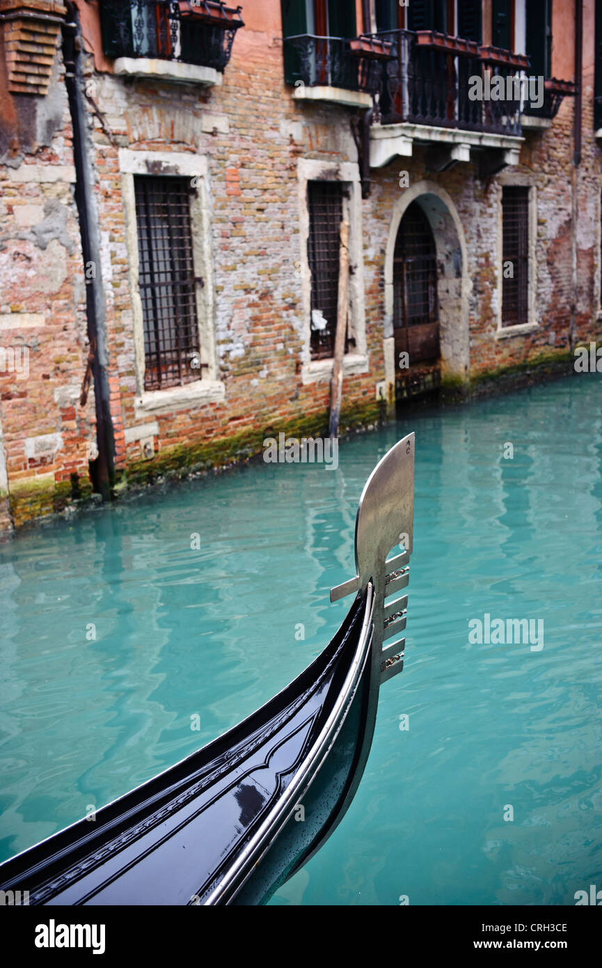 View of the front part of a Gondola in one of the canals of Venice ...