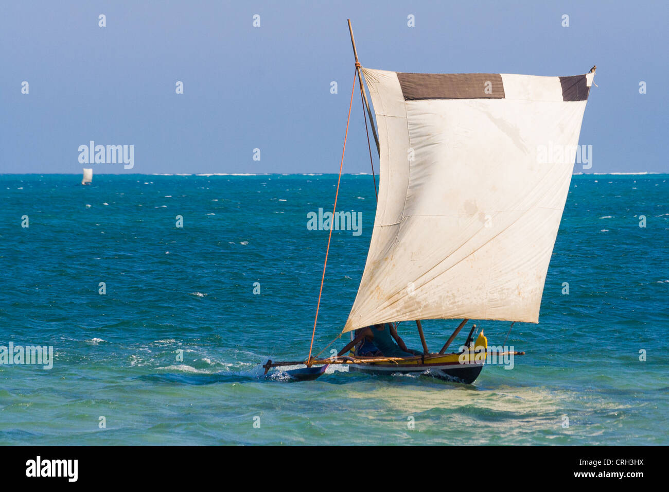 Malagasy outrigger pirogue with makeshift sails Stock Photo - Alamy