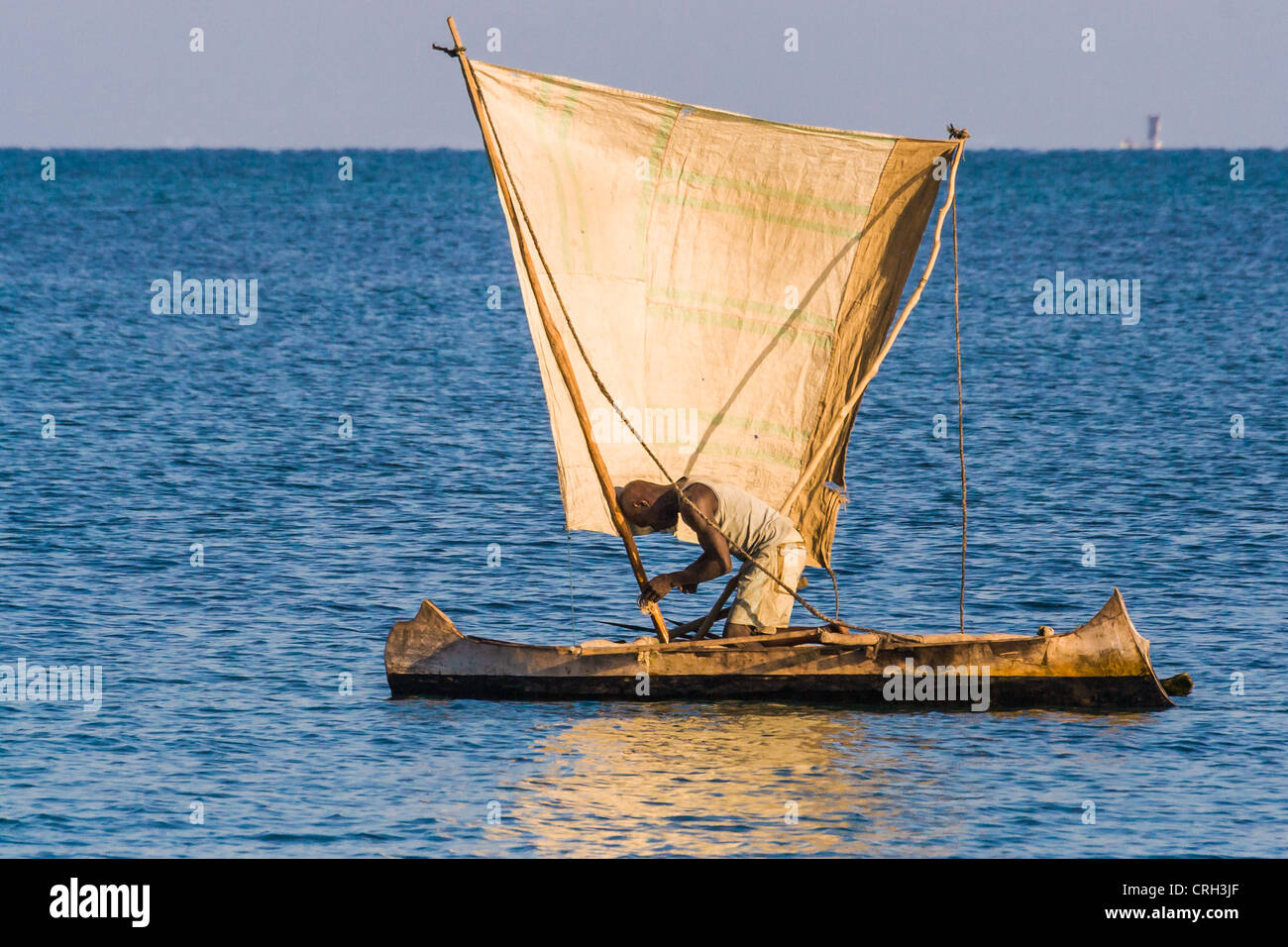 Malagasy outrigger pirogue with makeshift sails Stock Photo - Alamy