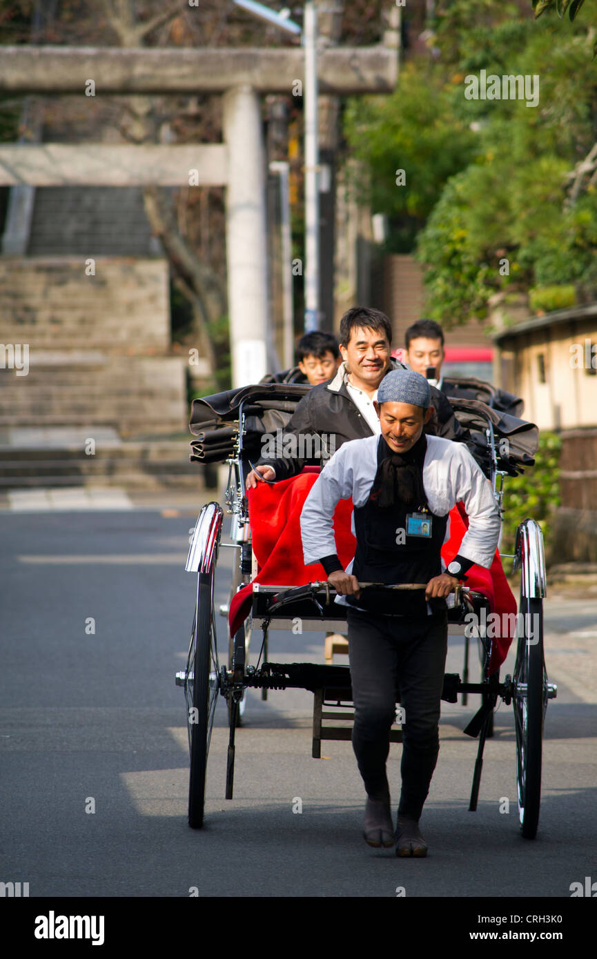 Rickshaw carrying passengers in a cart in Kamakura Stock Photo - Alamy