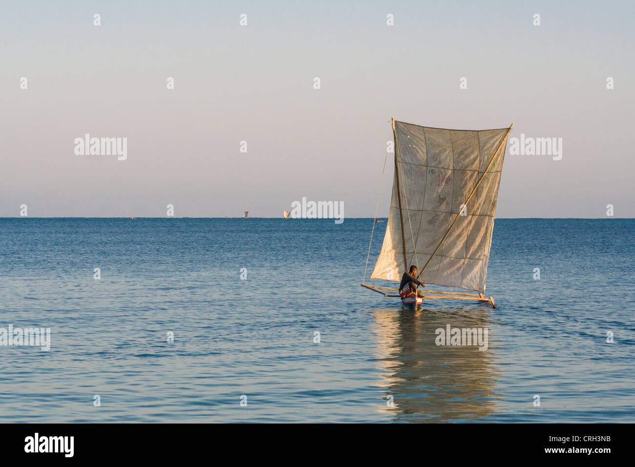 Malagasy outrigger pirogue with makeshift sails Stock Photo - Alamy