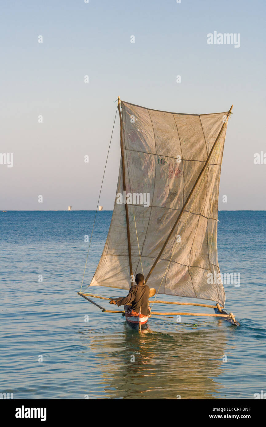 Malagasy outrigger pirogue with makeshift sails Stock Photo - Alamy