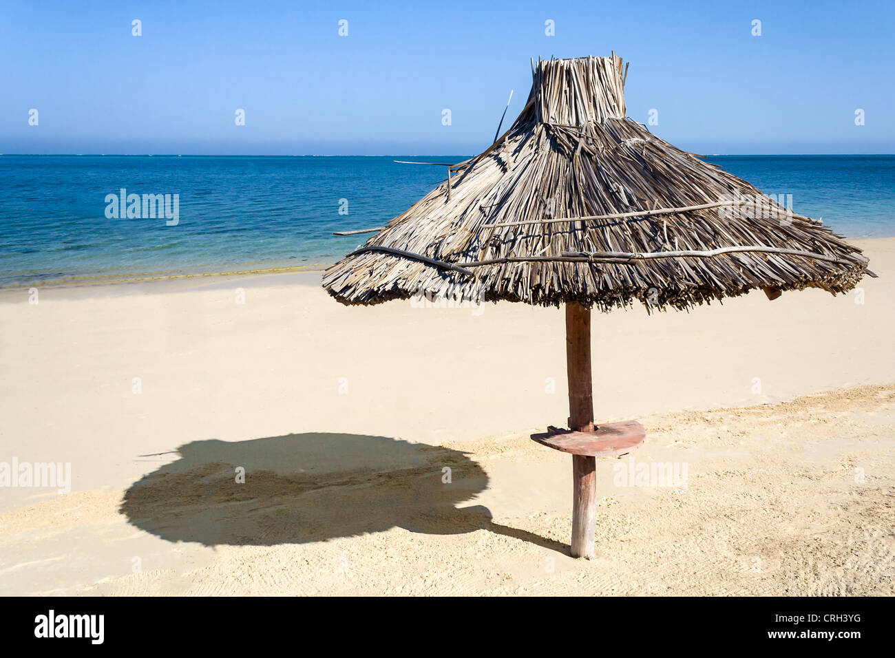 Straw parasol on the beach of Ifaty, western Madagascar Stock Photo - Alamy