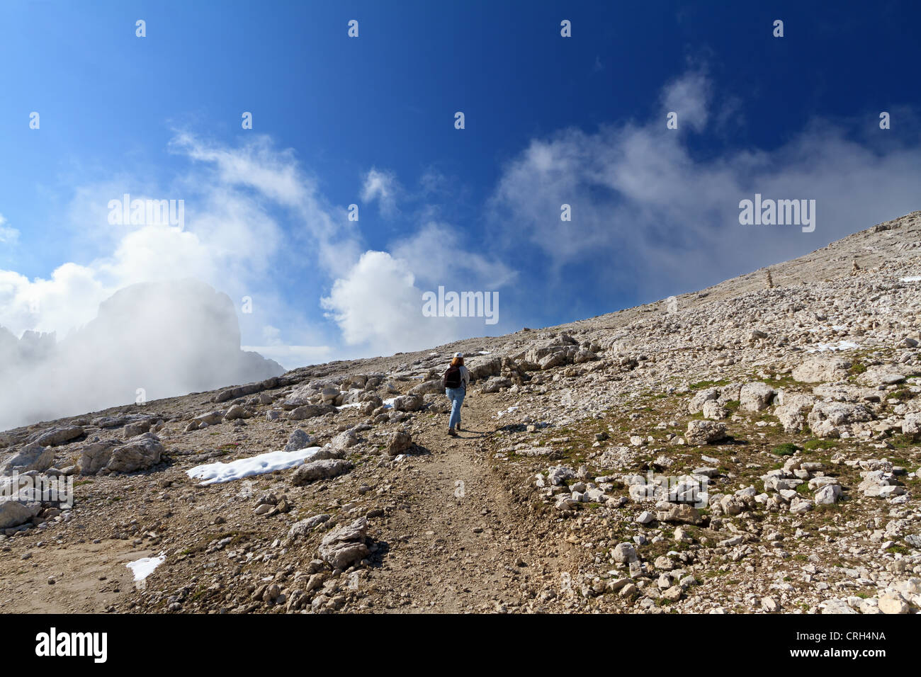 woman walks on alpine pathway - Rosetta mount, Trentino, Italy Stock ...
