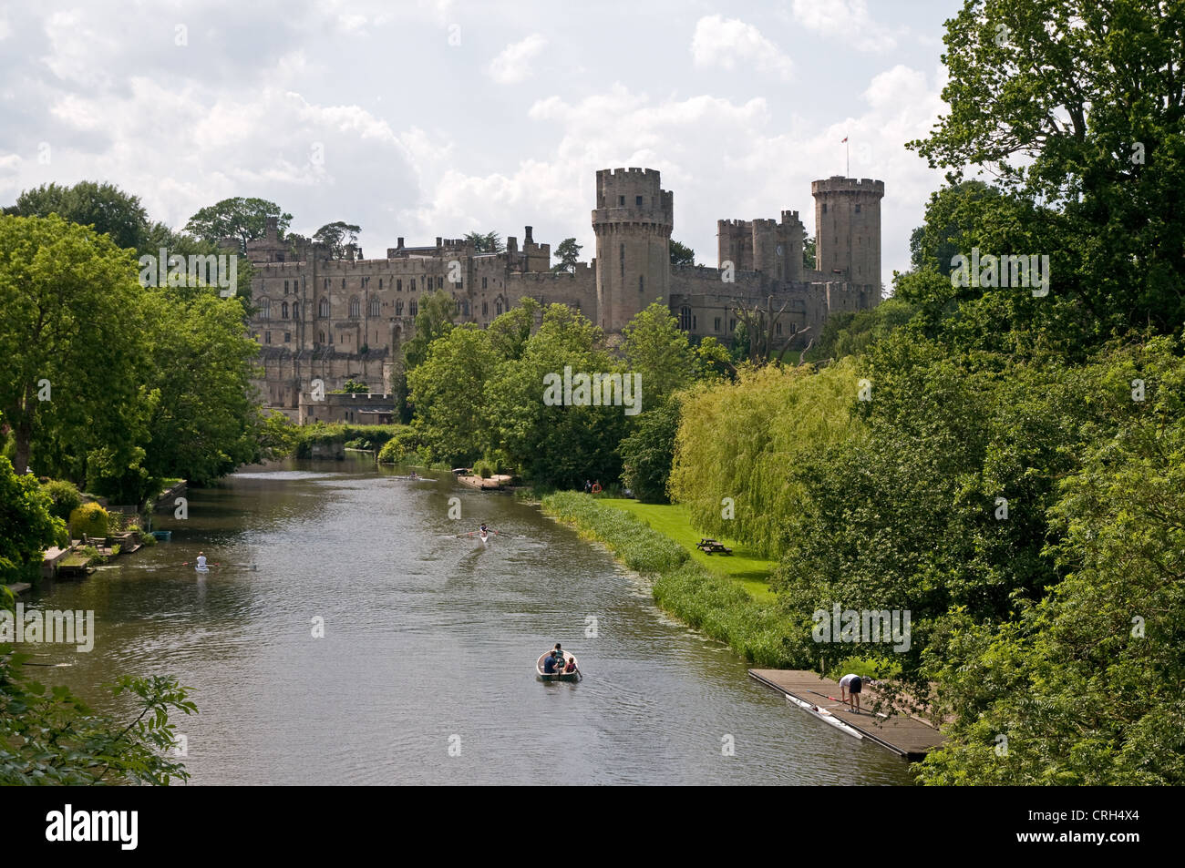 Warwick Castle with boats on the River Avon seen from Castle Bridge ...