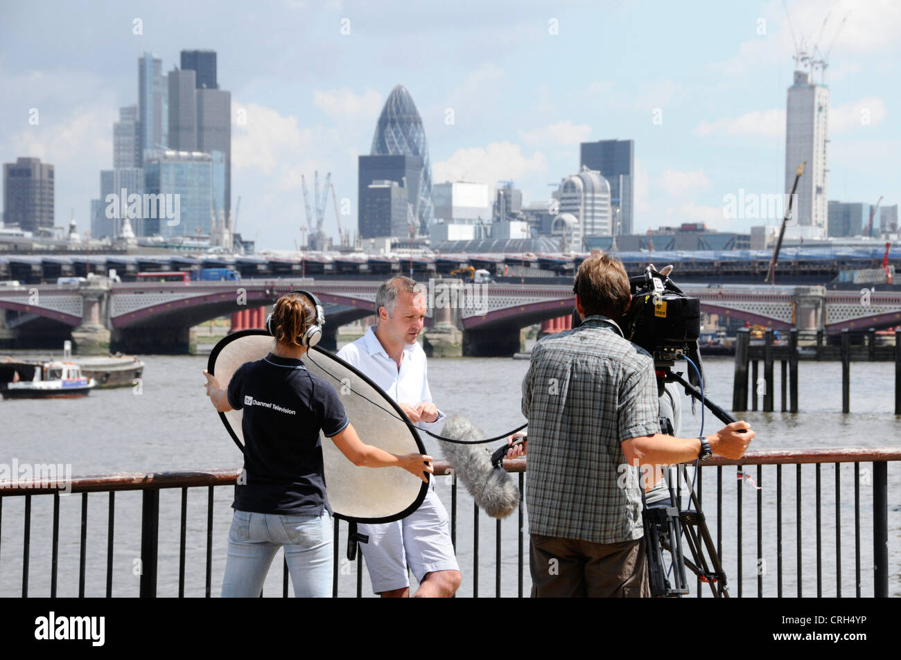 Camera crew filming an interview beside the River Thames with City of ...