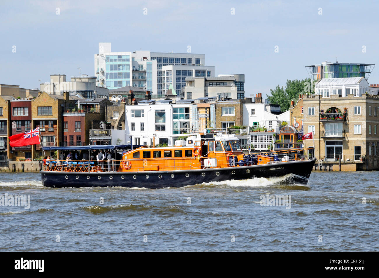 Motor launch Havengore on River Thames passing The Grapes riverside Inn ...