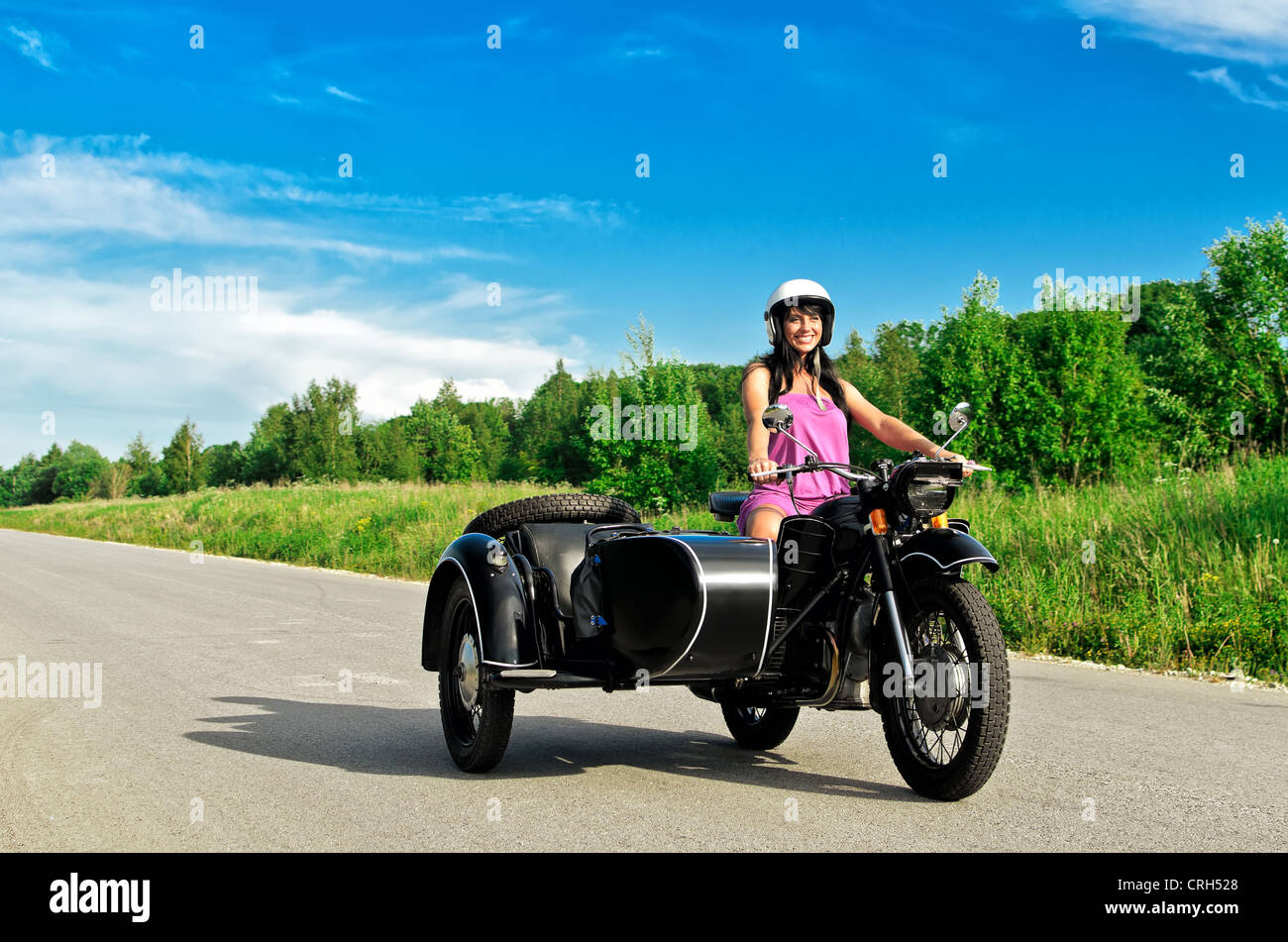 Pretty woman riding a motorcycle with a sidecar Stock Photo - Alamy
