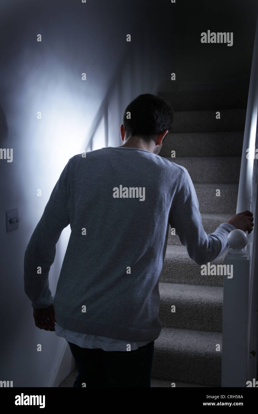 Young man walking upstairs back view Stock Photo - Alamy