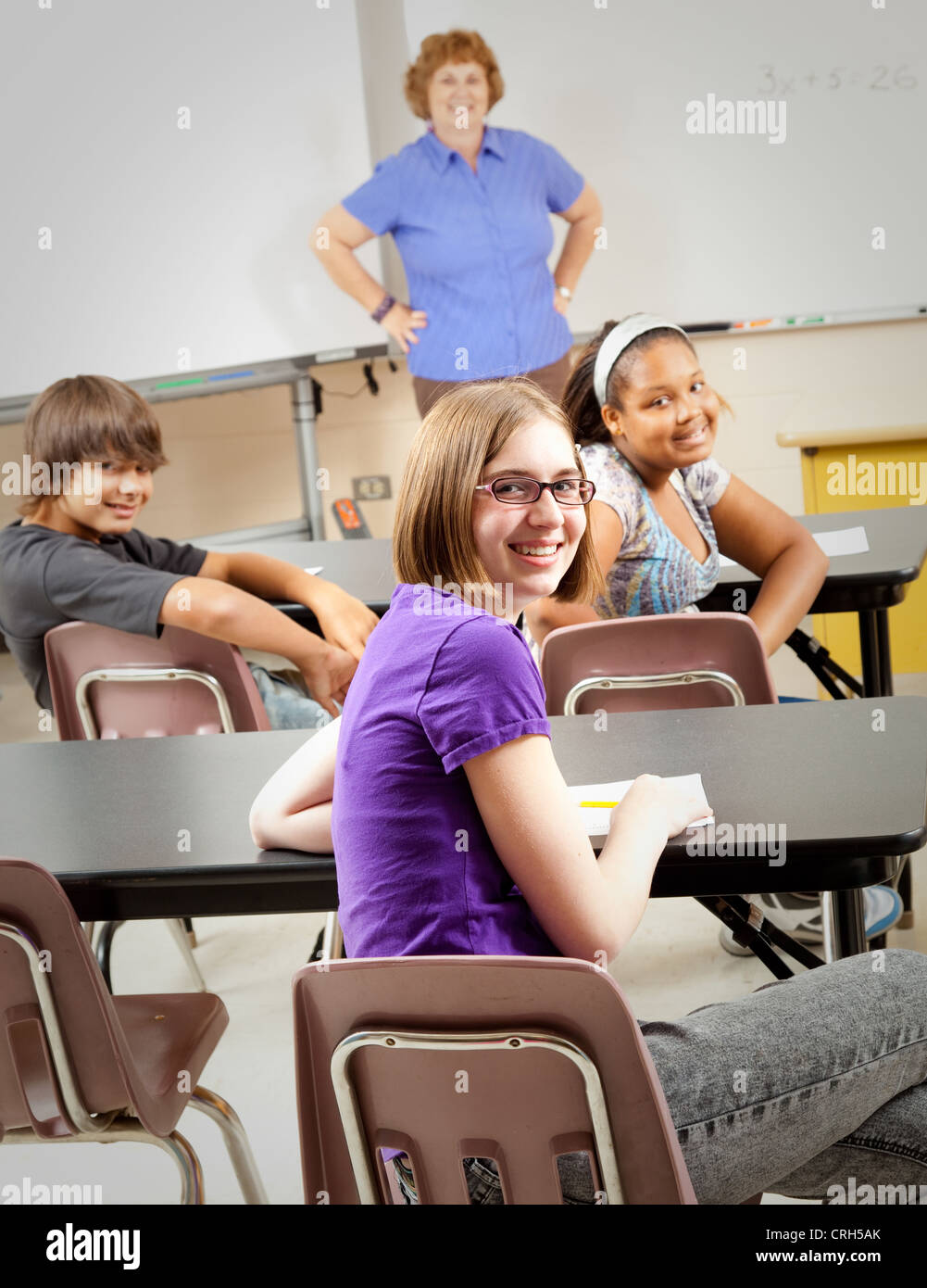 Portrait of teenage students and their teacher in the classroom. Focus ...