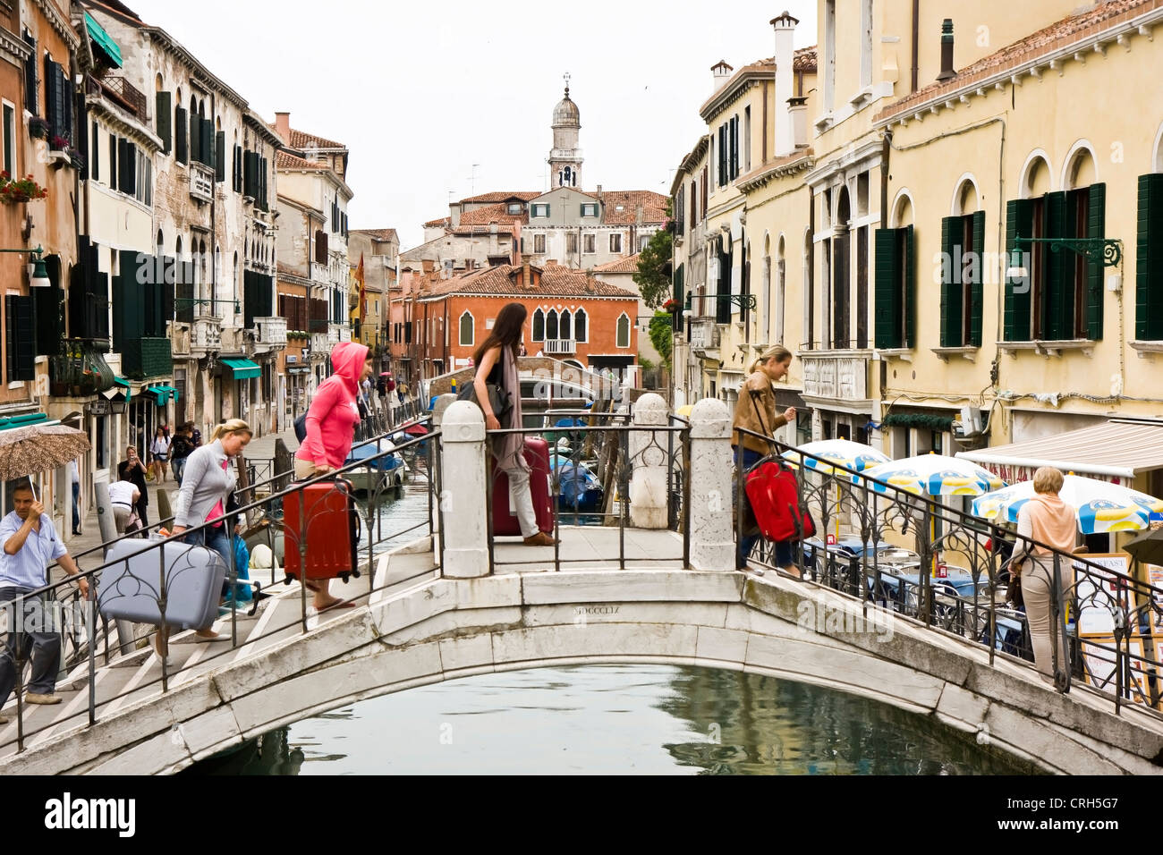 People crossing a bridge on a canal of Venice, Italy Stock Photo - Alamy