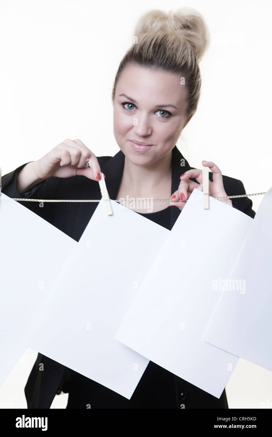 business woman hanging out blank piece of paper on a washing line using ...