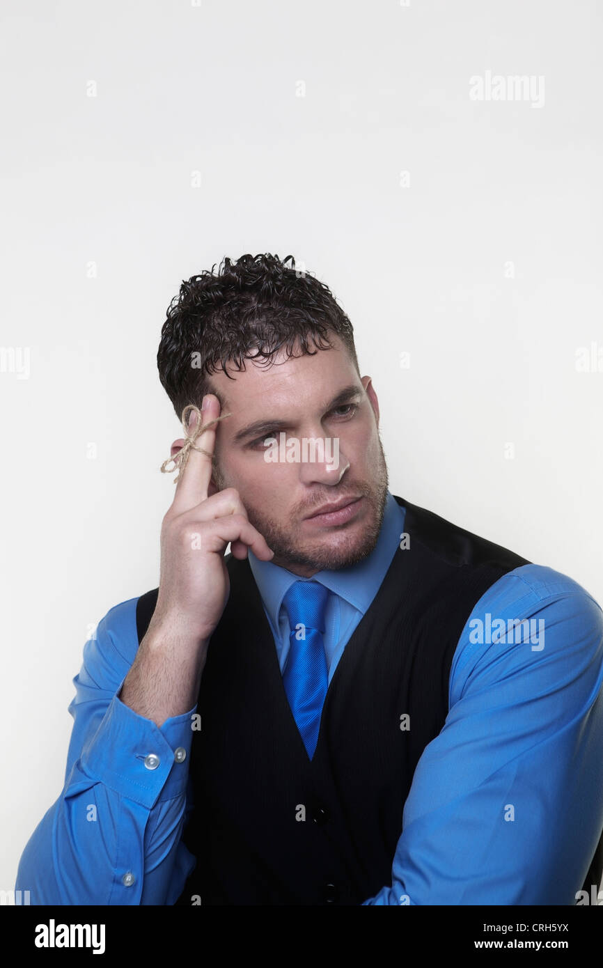 handsome business man with a piece of string tied round his finger so ...