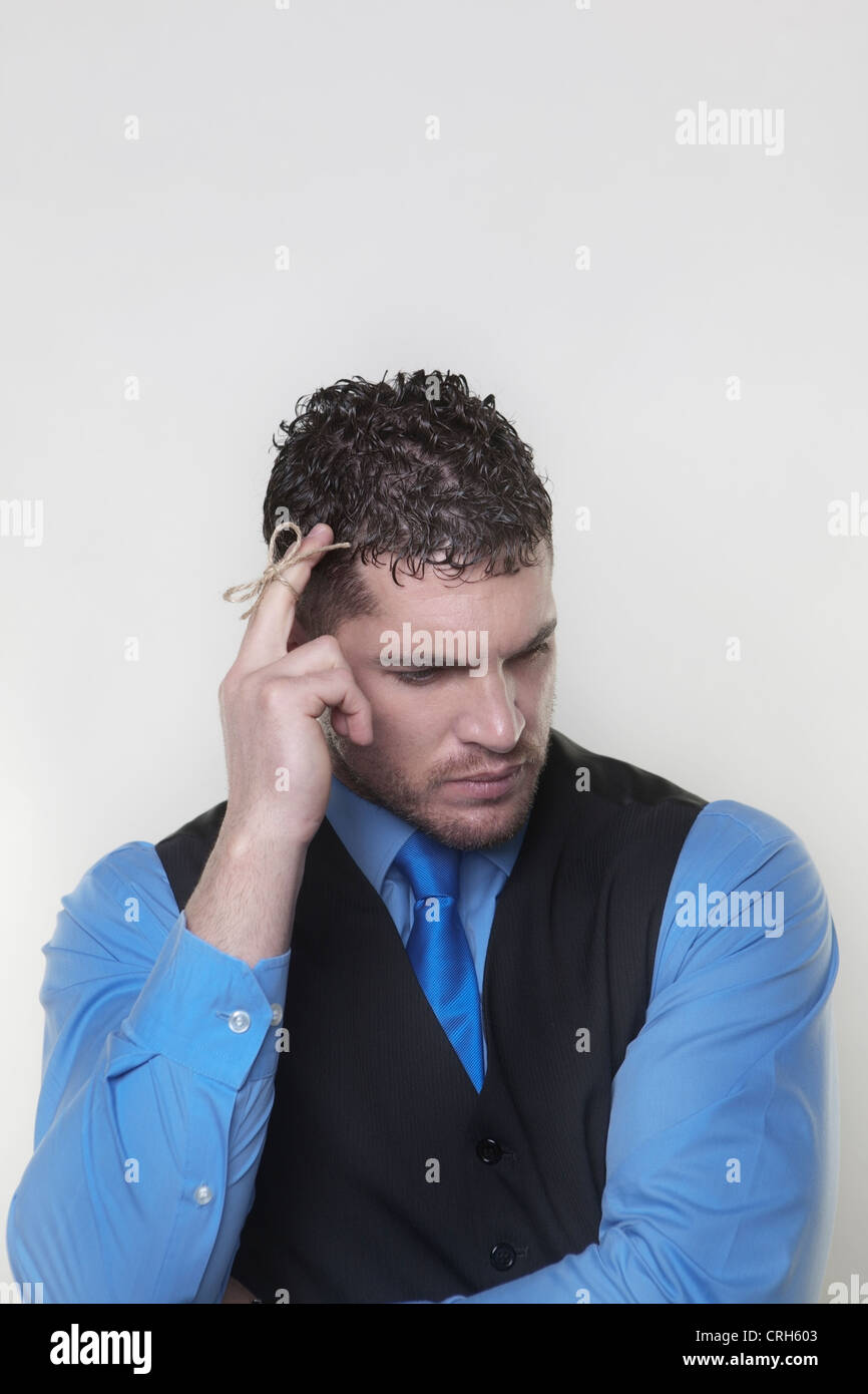 handsome business man with a piece of string tied round his finger so ...