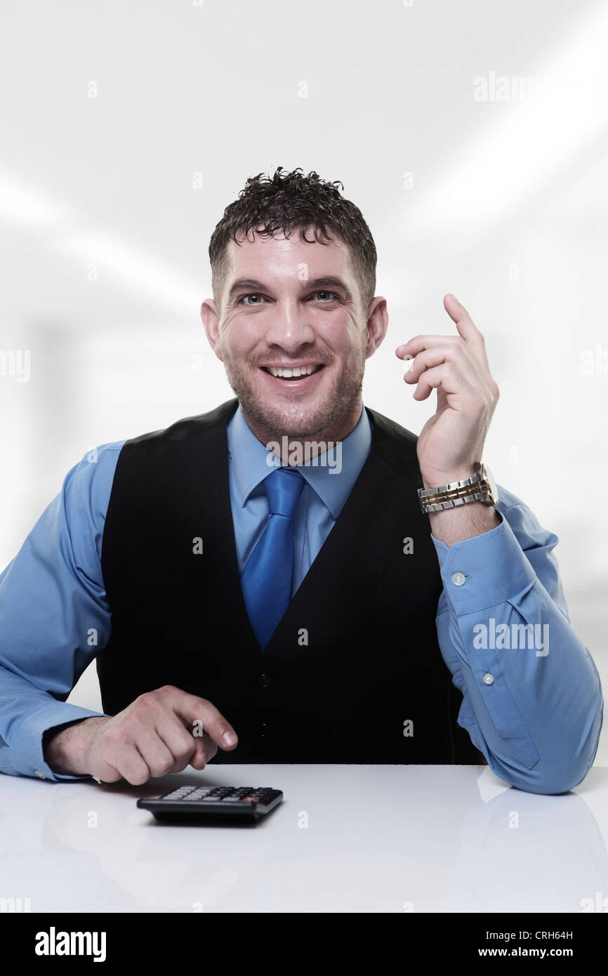 business man working at his desk adding up doing sums Stock Photo - Alamy