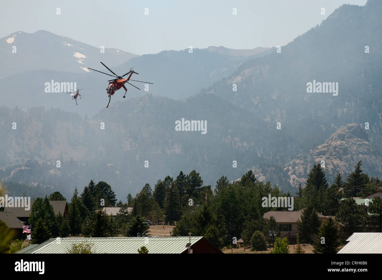 Forest Service helicopters take off after refilling their water tanks ...