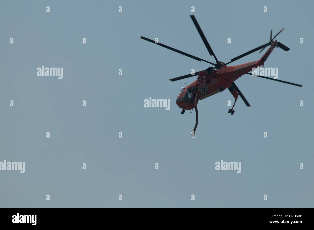 Forest Service helicopters take off after refilling their water tanks ...