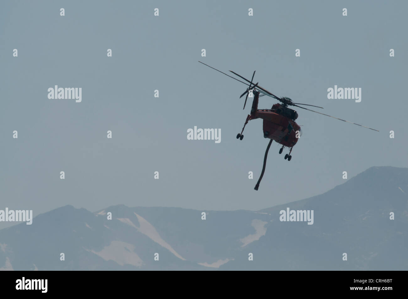 Forest Service helicopters take off after refilling their water tanks ...